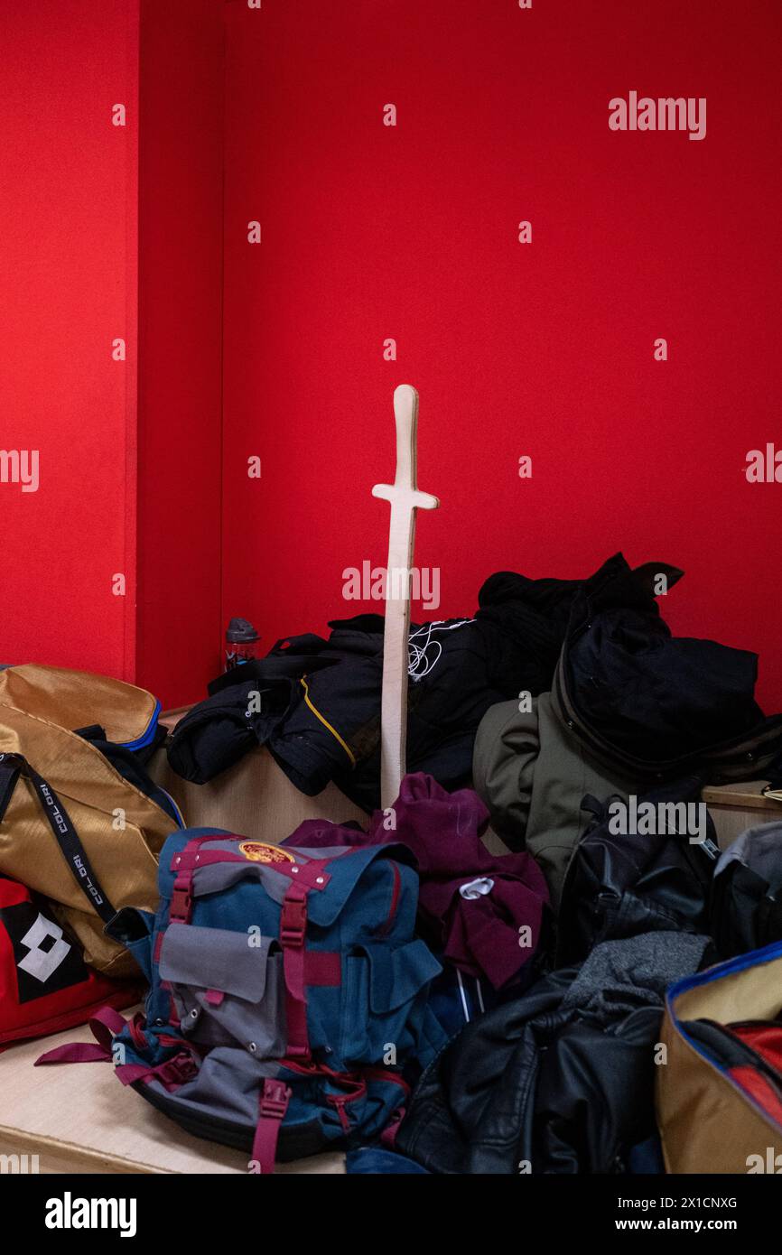 A wooden sword stuck in a pile of sacks and clothes like Excalibur in ...