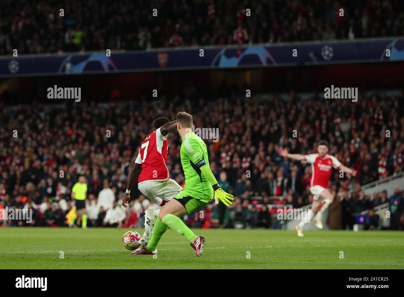 Manuel Neuer of Bayern Munich brings down Bukayo Saka of Arsenal but no ...