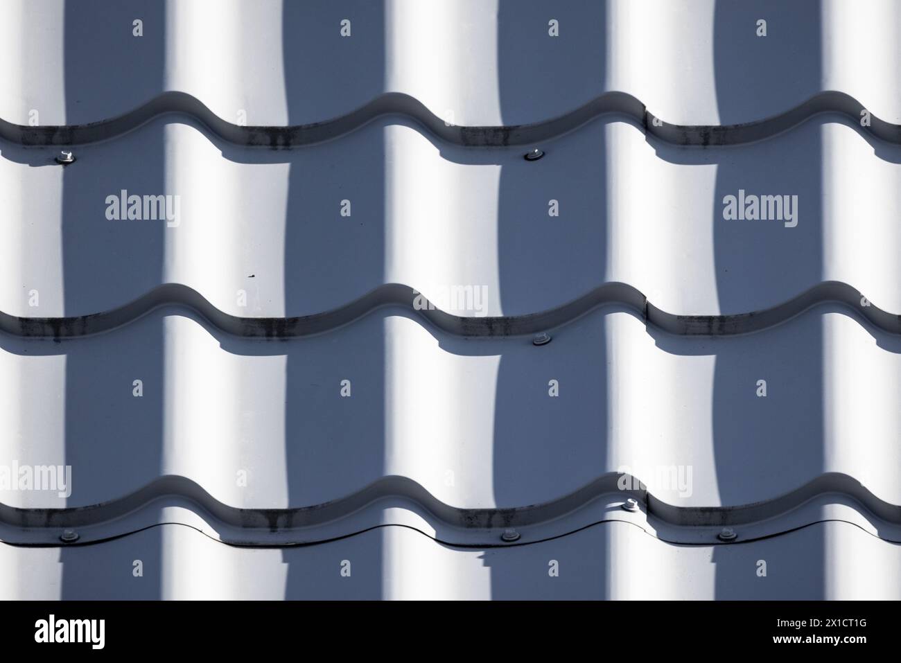 White metal tile roofing pattern with blue shadows, close-up background ...