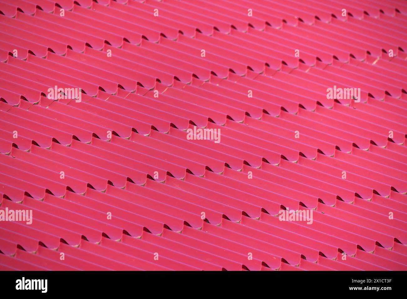 Red metal shingles roof slope, background photo texture Stock Photo - Alamy