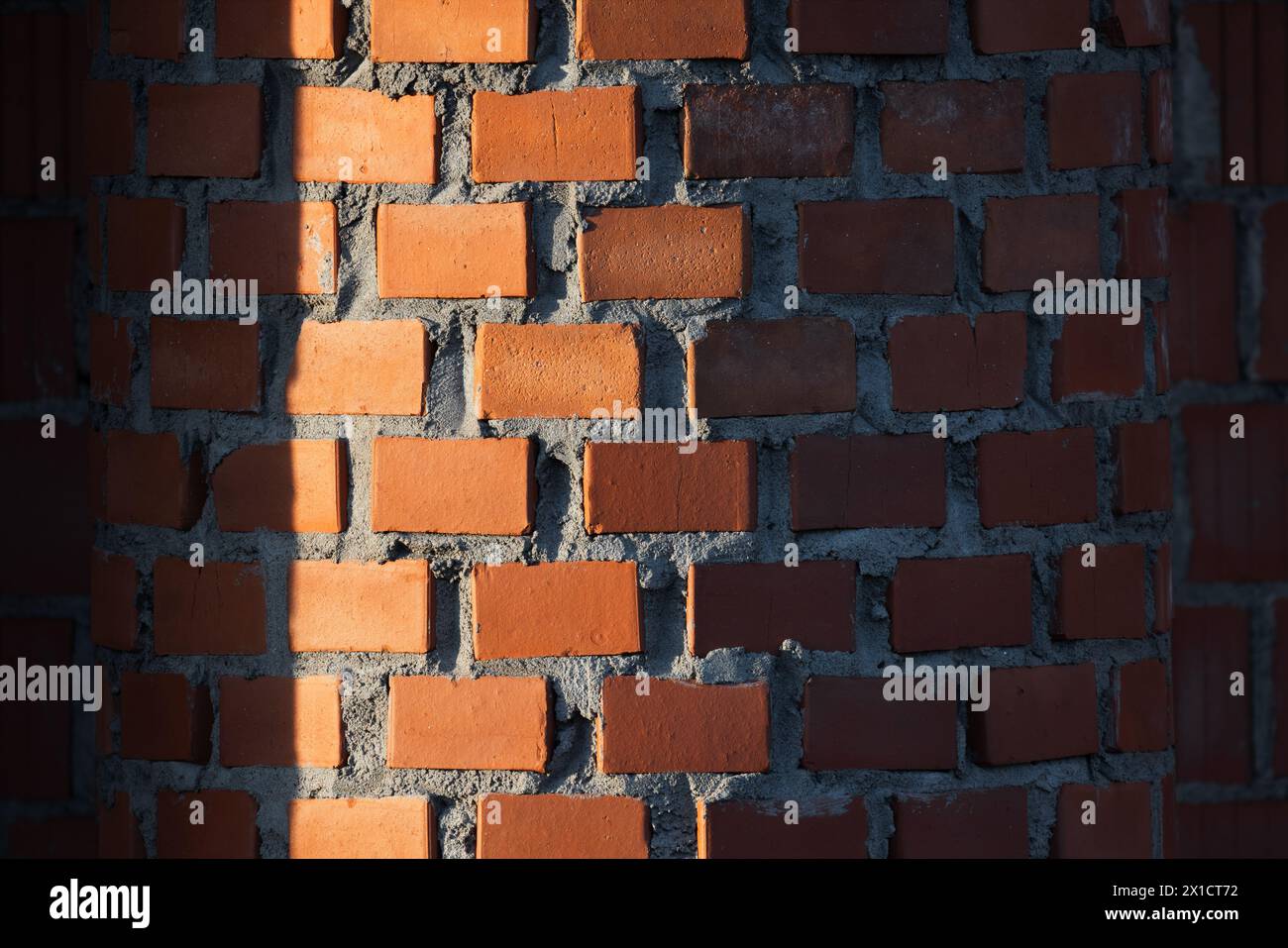 Red round brick wall pattern with deep shadows. Abstract photo ...
