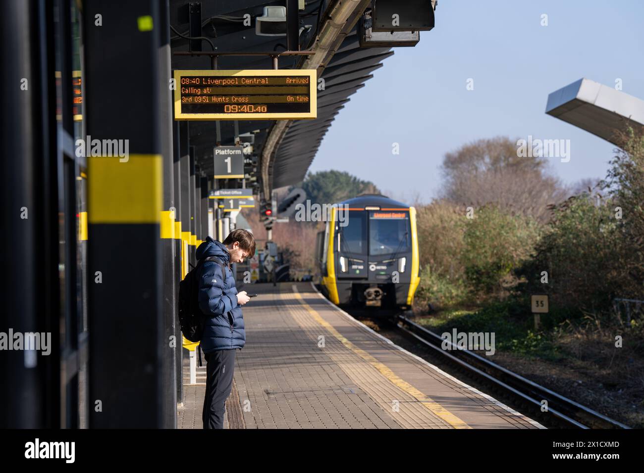 Merseyrail train arriving at station platform in daylight Stock Photo ...