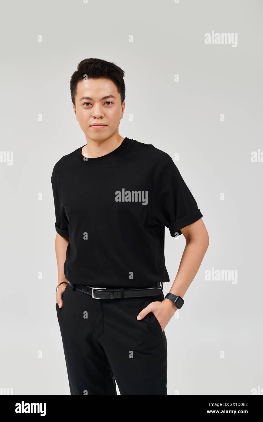 A fashionable young man in elegant attire striking a confident pose ...