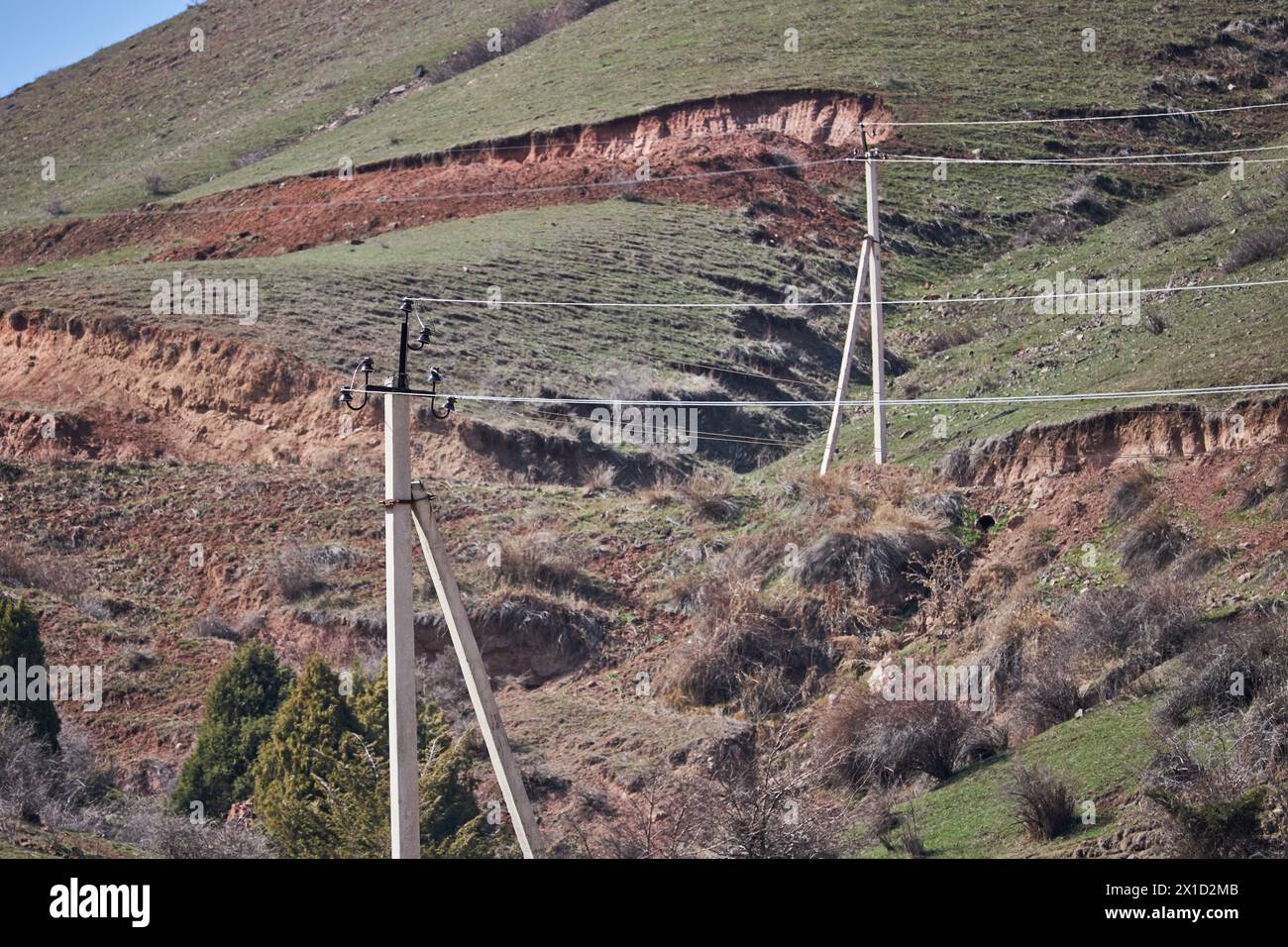 Two concrete pillar, old power line with small power flows at low ...