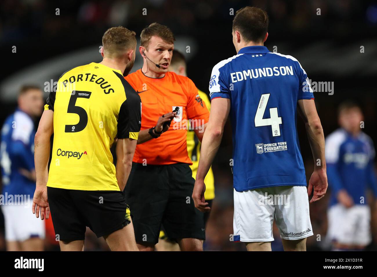 Referee, Sam Barrett speaks to George Edmundson of Ipswich Town and ...