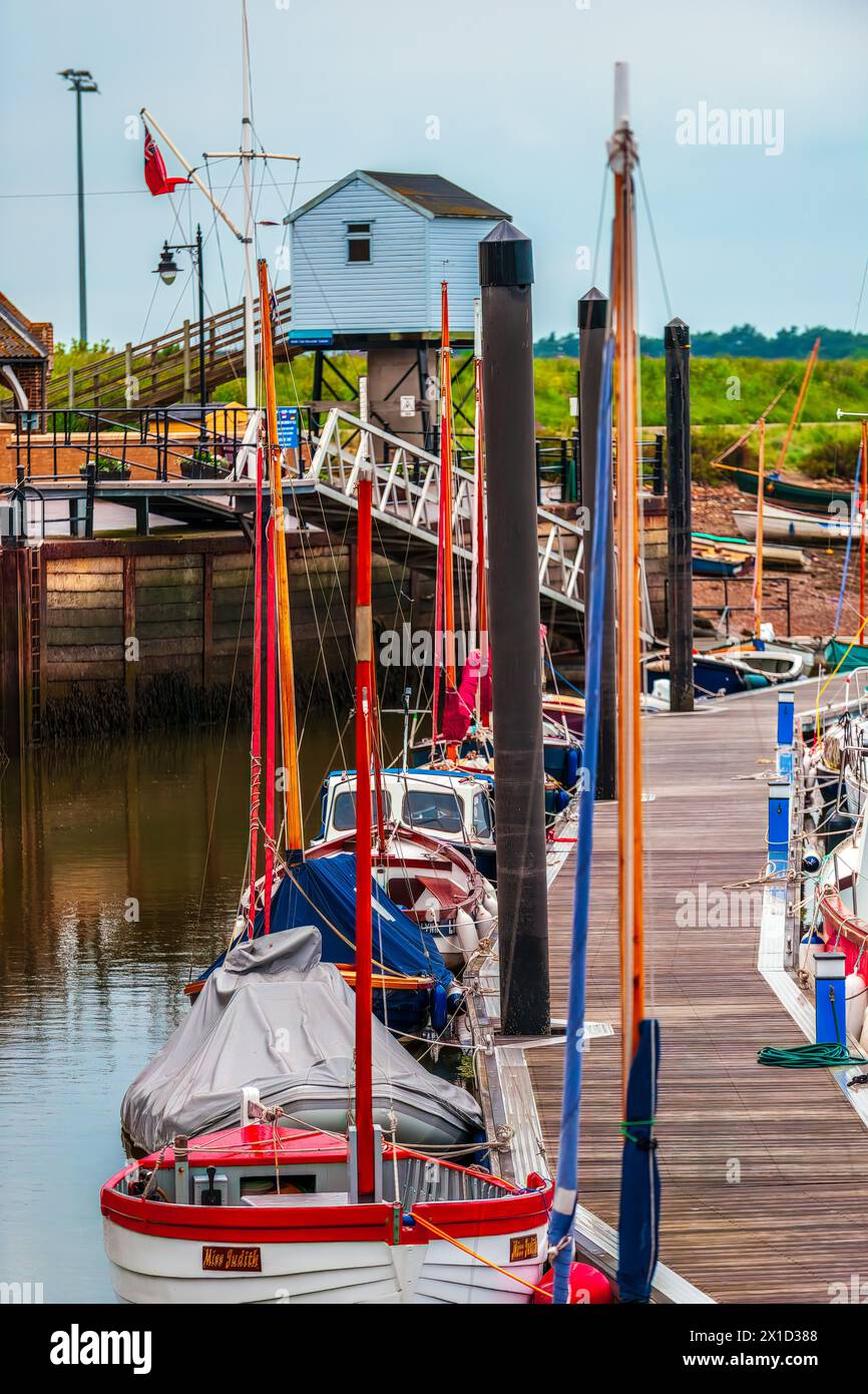 Boats moored along a wooden pontoon at the quayside at Wells next the ...