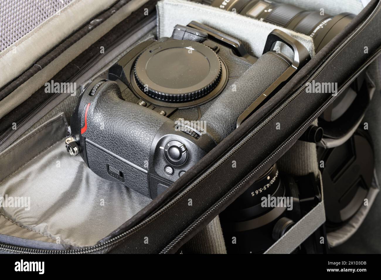 Professional camera equipment being loaded into a partially open ...