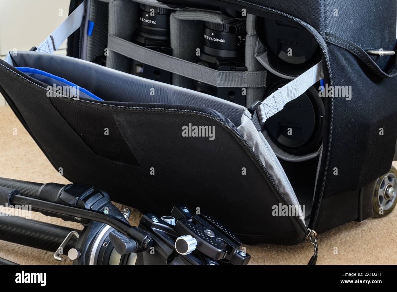 Professional camera equipment being loaded into a partially open ...