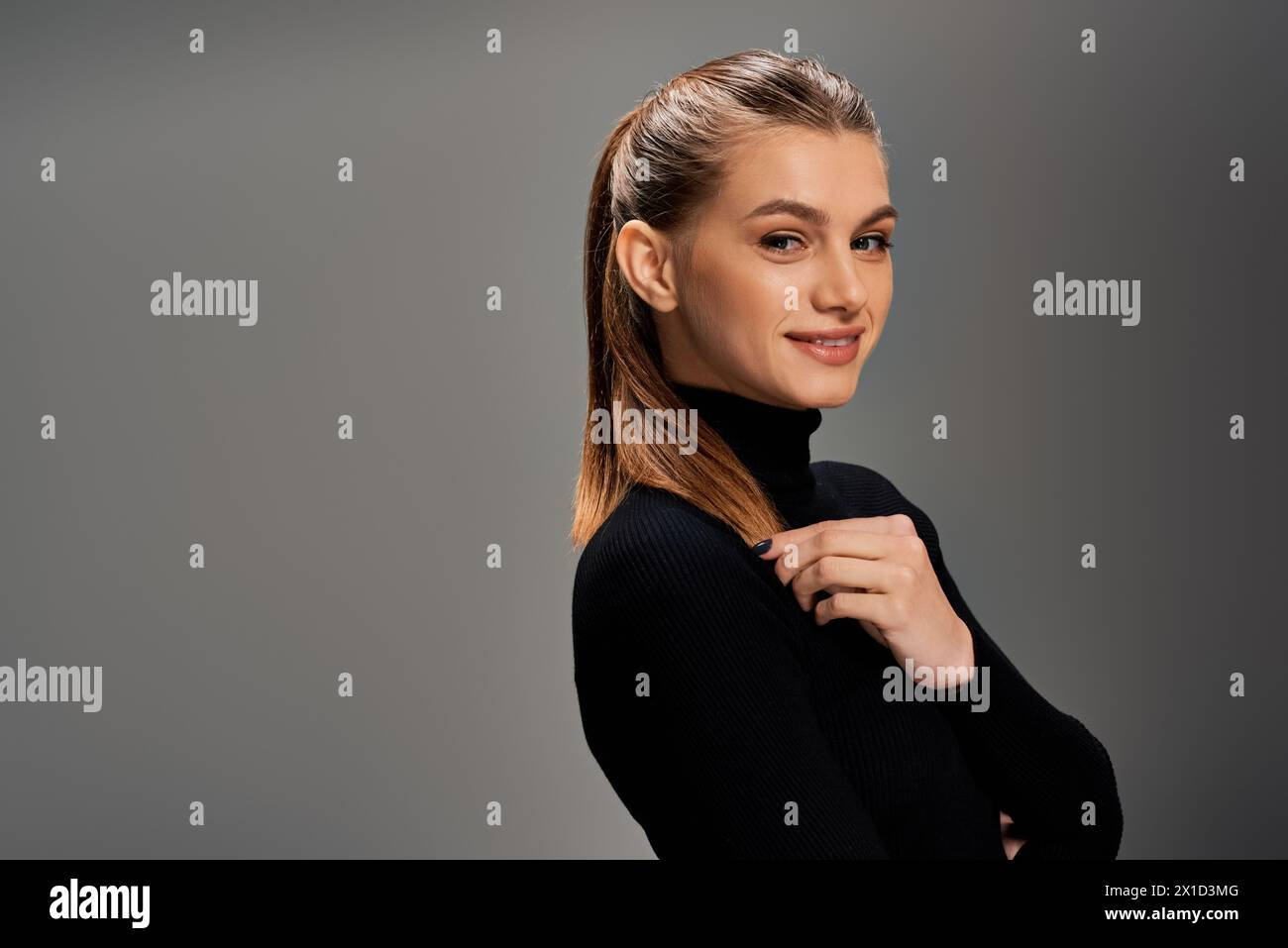 A young jolly woman exudes elegance in a black sweater, her long hair ...