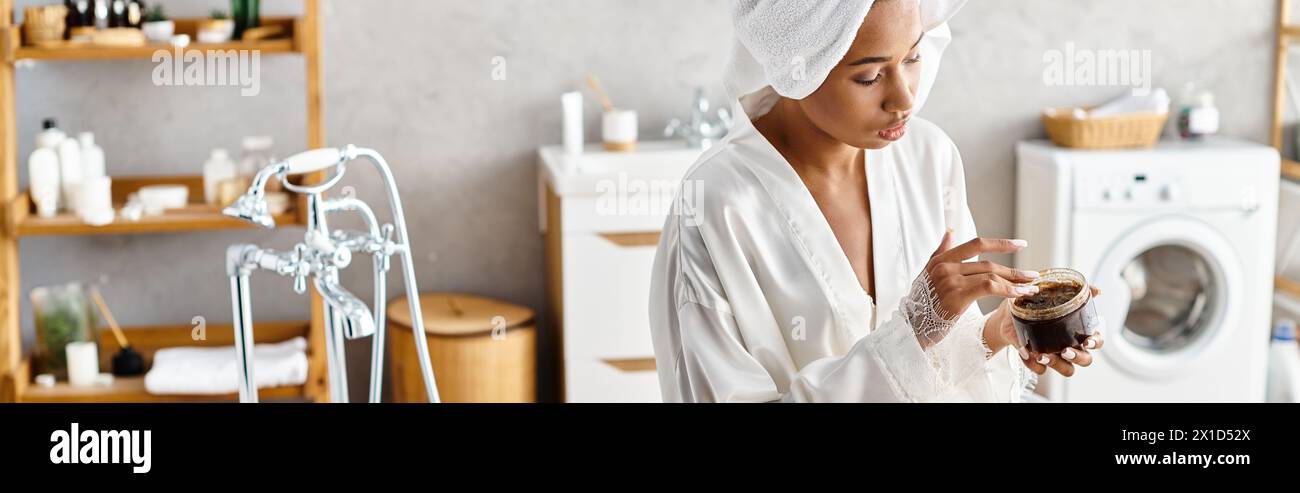 An African American woman in bathrobe exfoliating body with scrub Stock ...