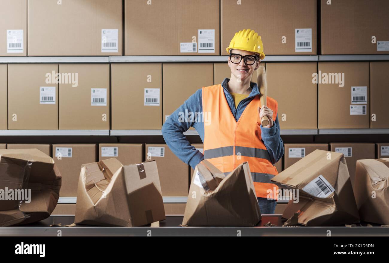 Confident smiling rebellious worker posing with a baseball bat at the ...