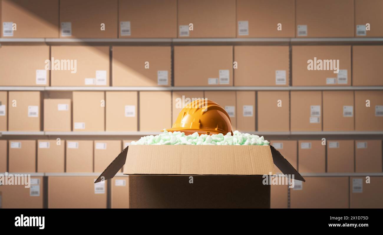 Safety and health at work: protective safety helmet in a delivery box ...