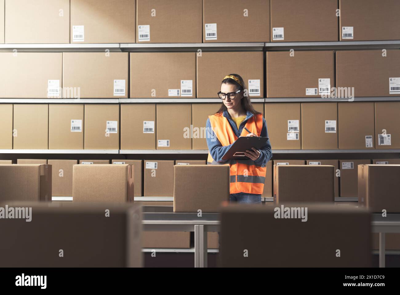 Female employee checking parcel hi-res stock photography and images - Alamy