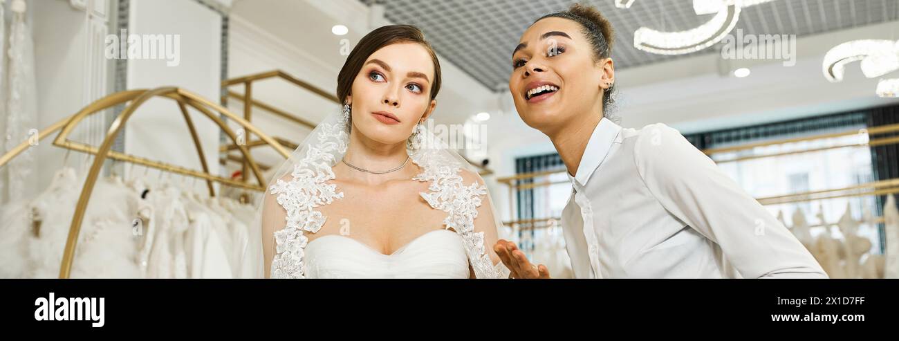 A young brunette bride in a wedding dress is accompanied by an African ...