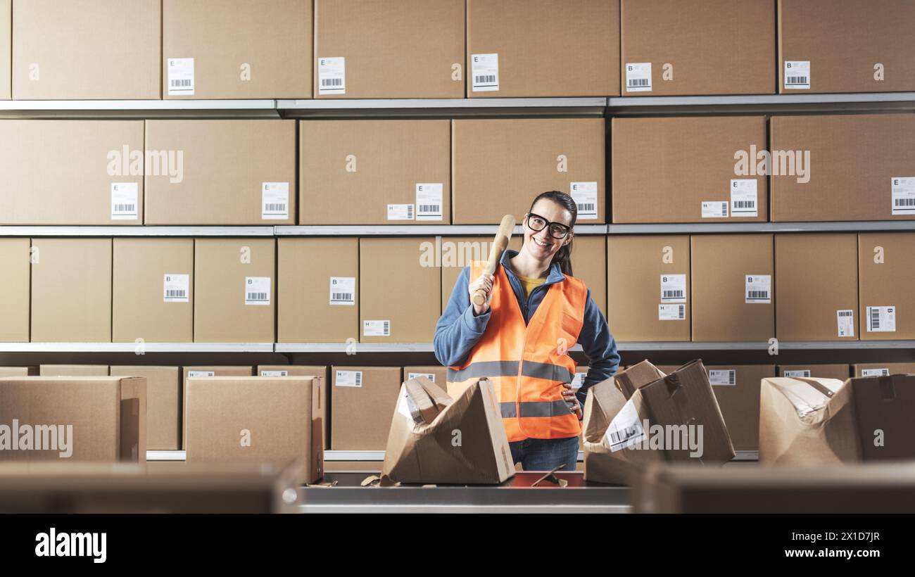Confident smiling rebellious worker posing with a baseball bat at the ...