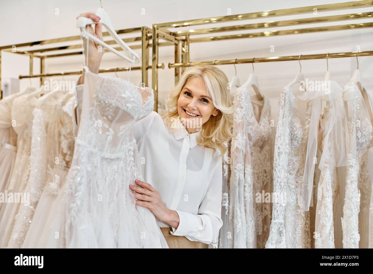 A middle-aged beautiful shopping assistant stands gracefully in front ...