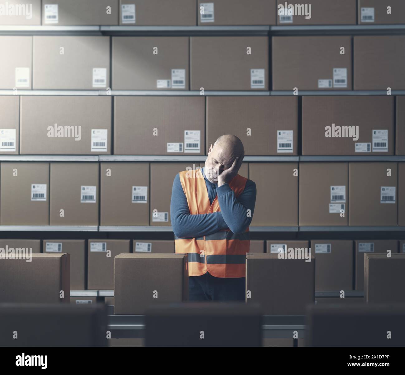 Exhausted distracted warehouse worker falling asleep while checking the ...
