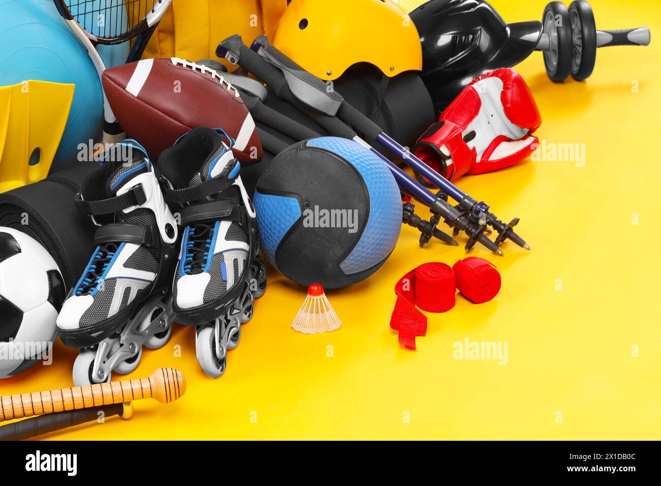 Many different sports equipment on yellow background Stock Photo - Alamy