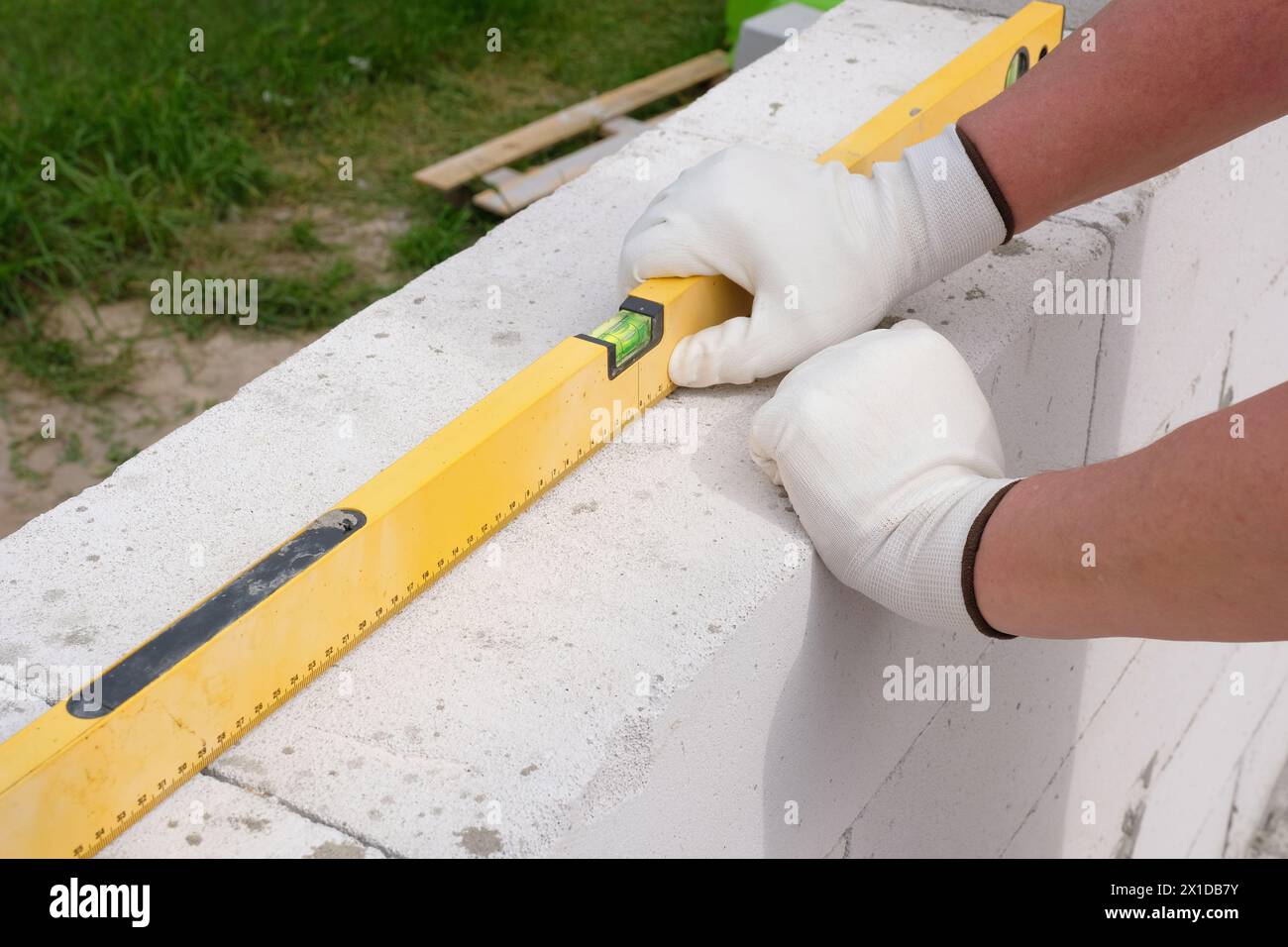 The hands of the builder measure the level of the plane using a ...