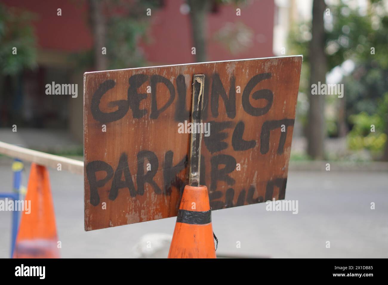 A sign that says "gedung elit parkir sulit" in Indonesian which means ...