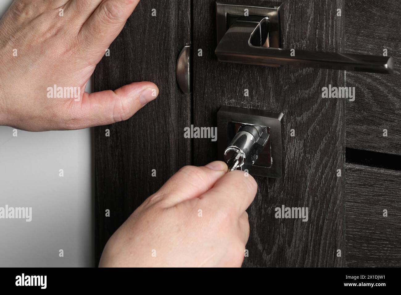 Handyman changing core of door lock indoors, closeup Stock Photo - Alamy