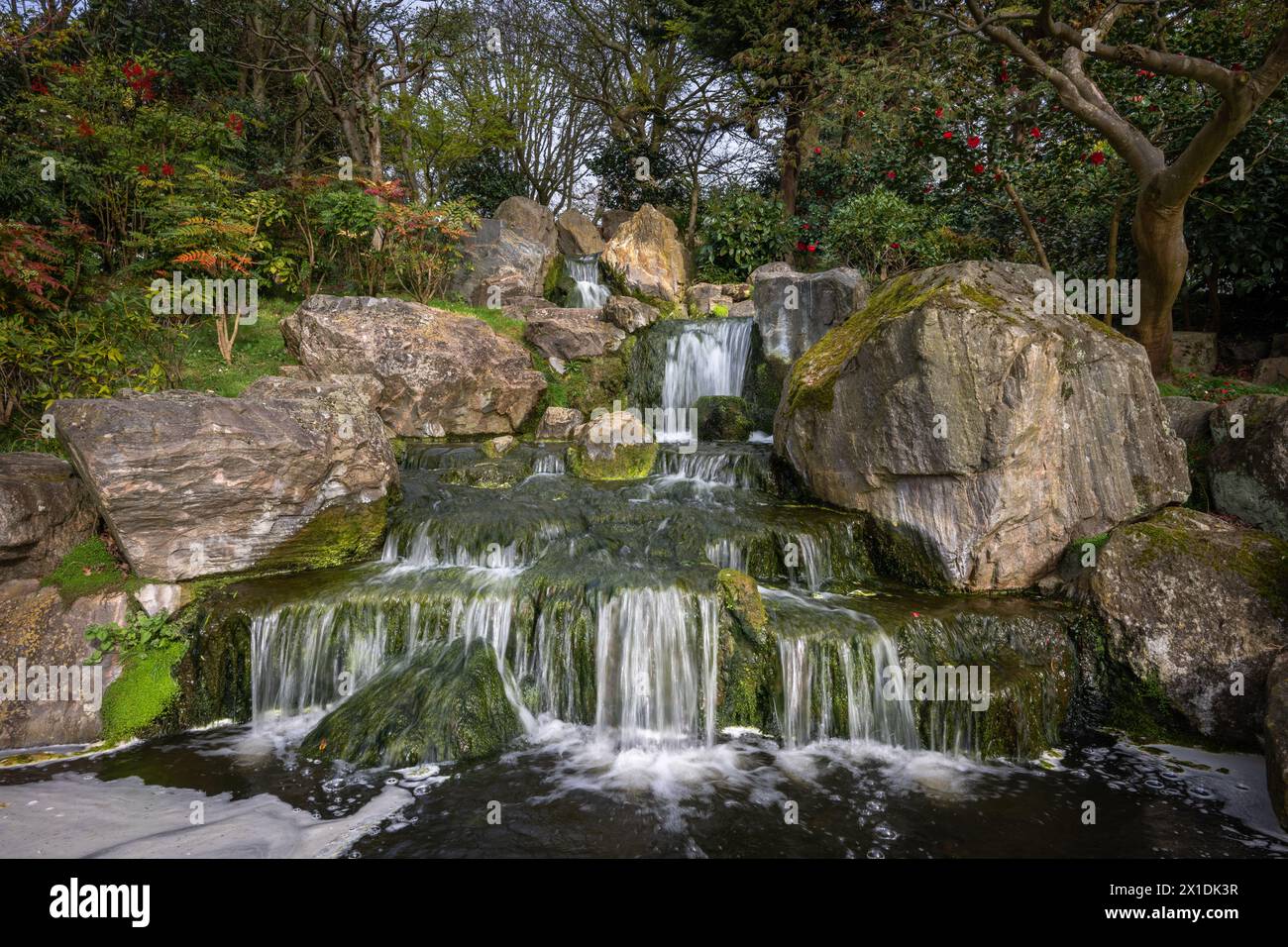 Waterfall in Kyoto Garden, a Japanese garden in Holland Park, London, UK. Holland Park is a ...