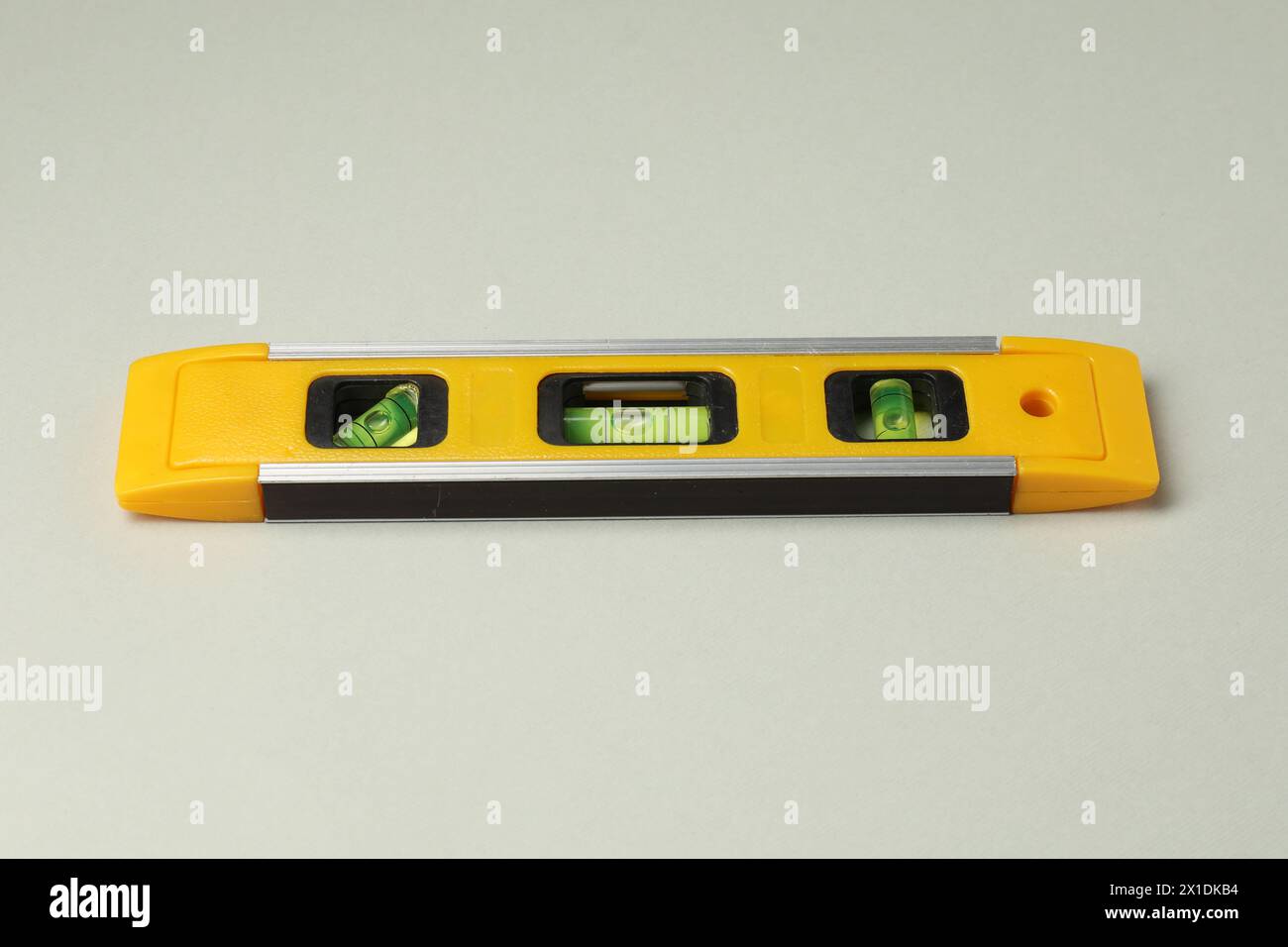 One yellow building level on beige background Stock Photo - Alamy