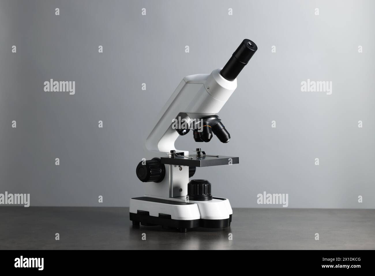 Modern medical microscope on grey table against light background Stock ...