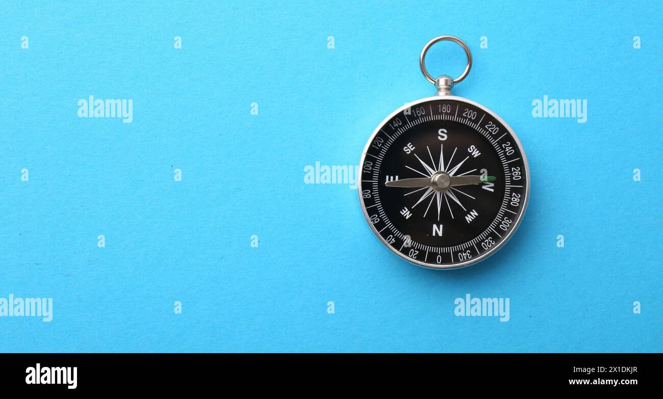One compass on light blue background, top view. Space for text Stock ...