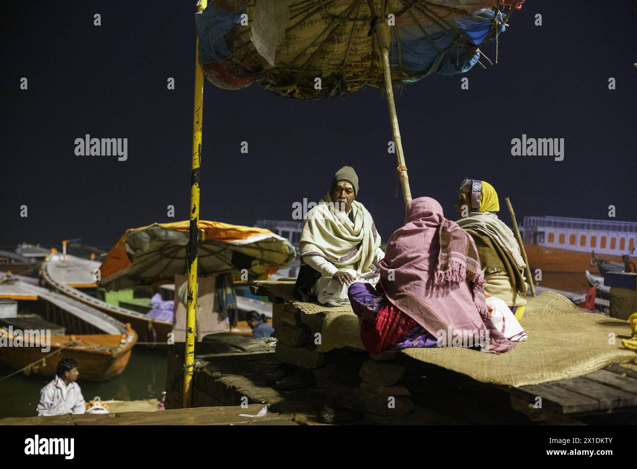 Pujari or Hindu priest performing rituals for pilgrims in the predawn ...
