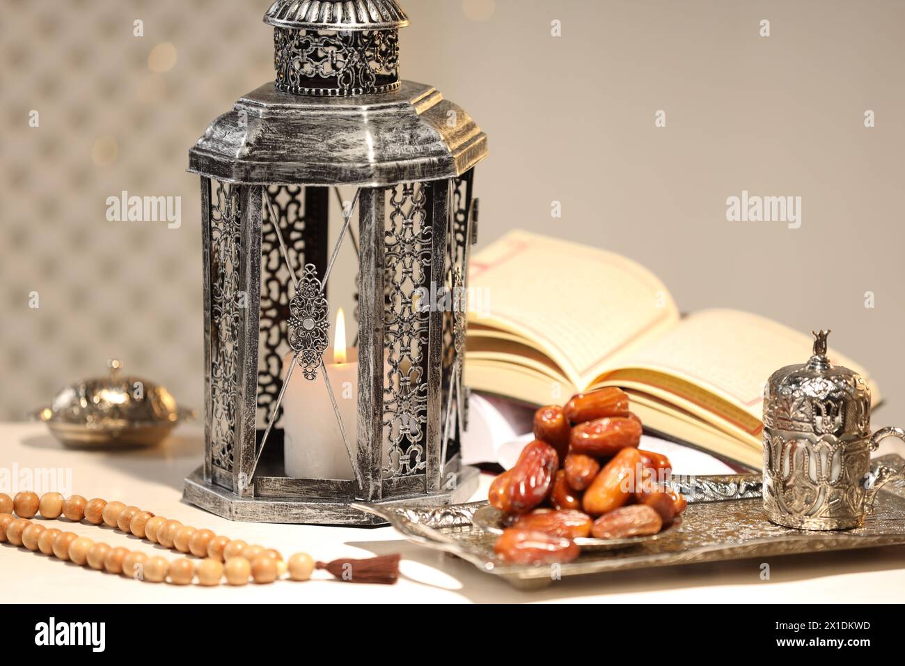 Arabic lantern, Quran, misbaha and dates on white table Stock Photo - Alamy