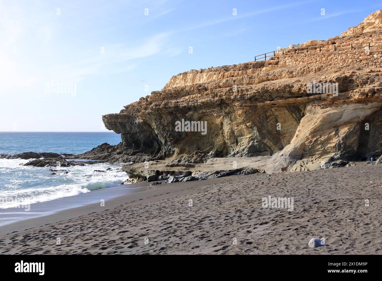 Ajuy beach, made up of black volcanic sand and stones, located on the ...