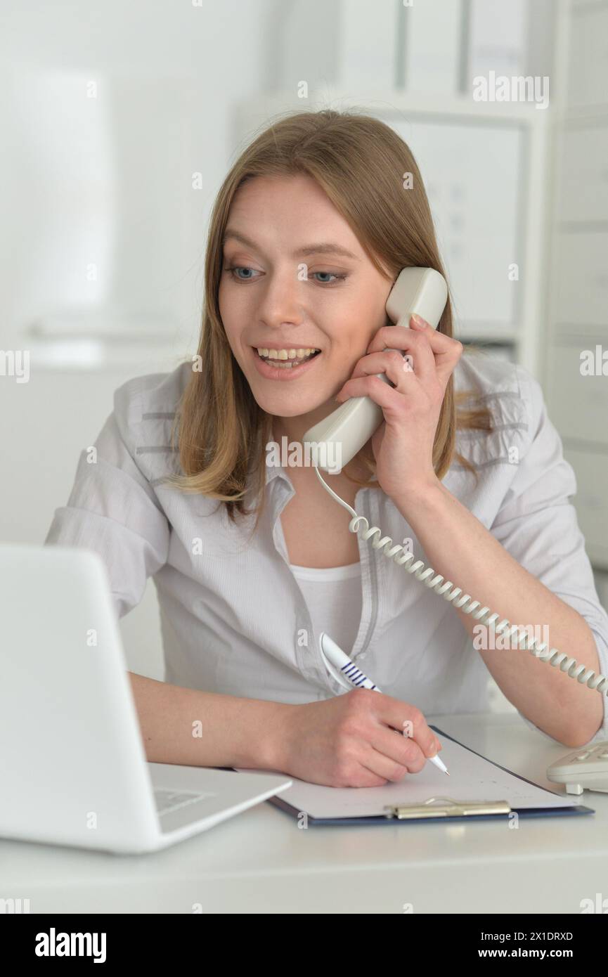 Female office worker reacting to phone call Stock Photo - Alamy