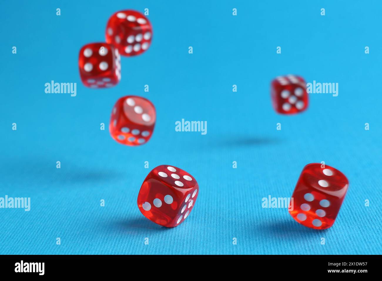 Many red game dices falling on light blue background Stock Photo - Alamy