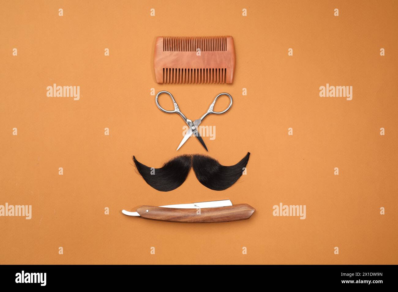 Artificial moustache and barber tools on orange background, flat lay ...