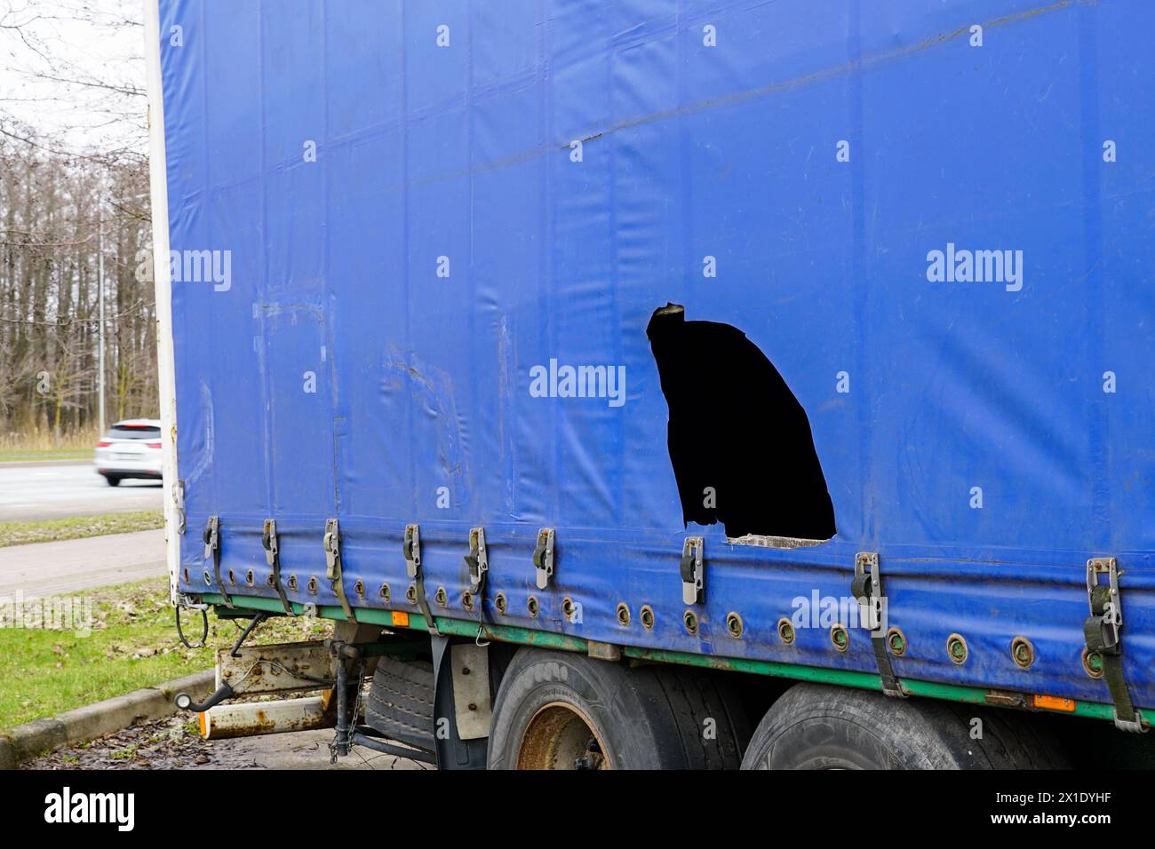 Truck trailer with blue damaged awning, cargo theft problem by cutting ...