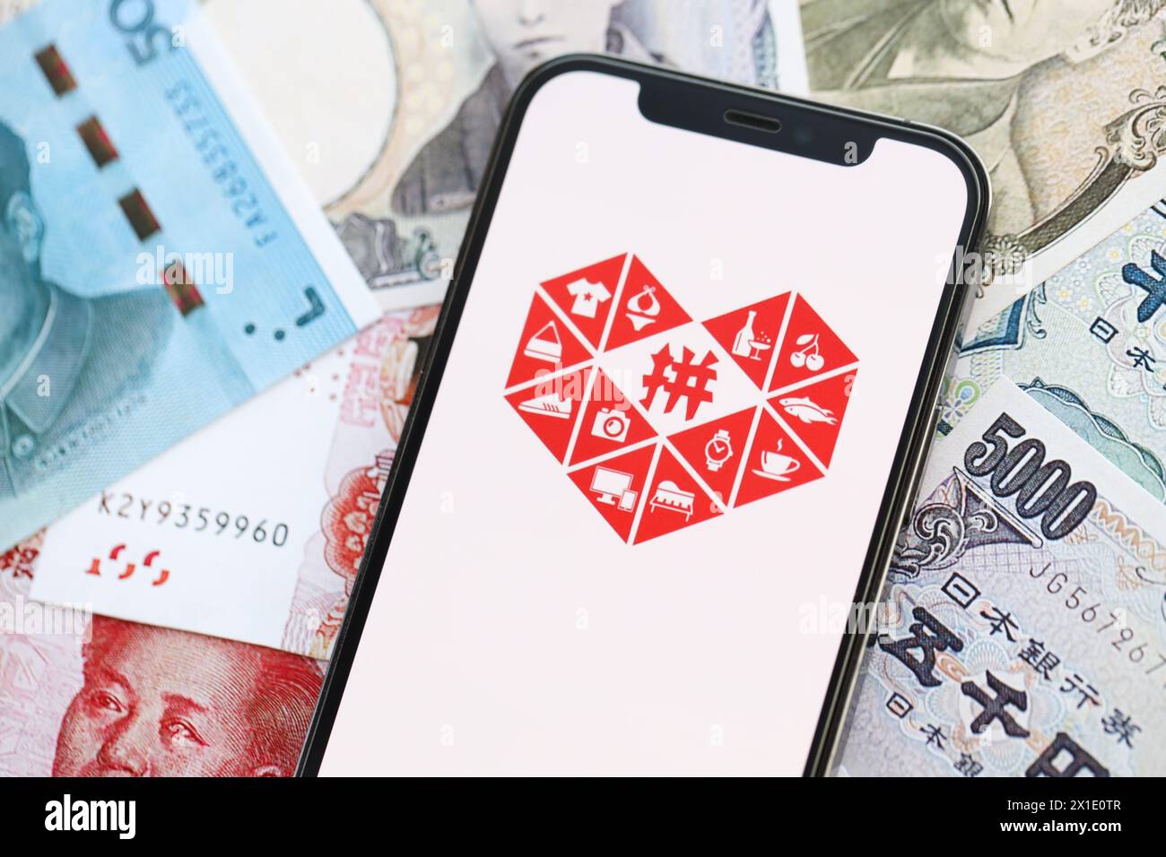 KYIV, UKRAINE - APRIL 1, 2024 Pinduoduo icon on smartphone screen on ...