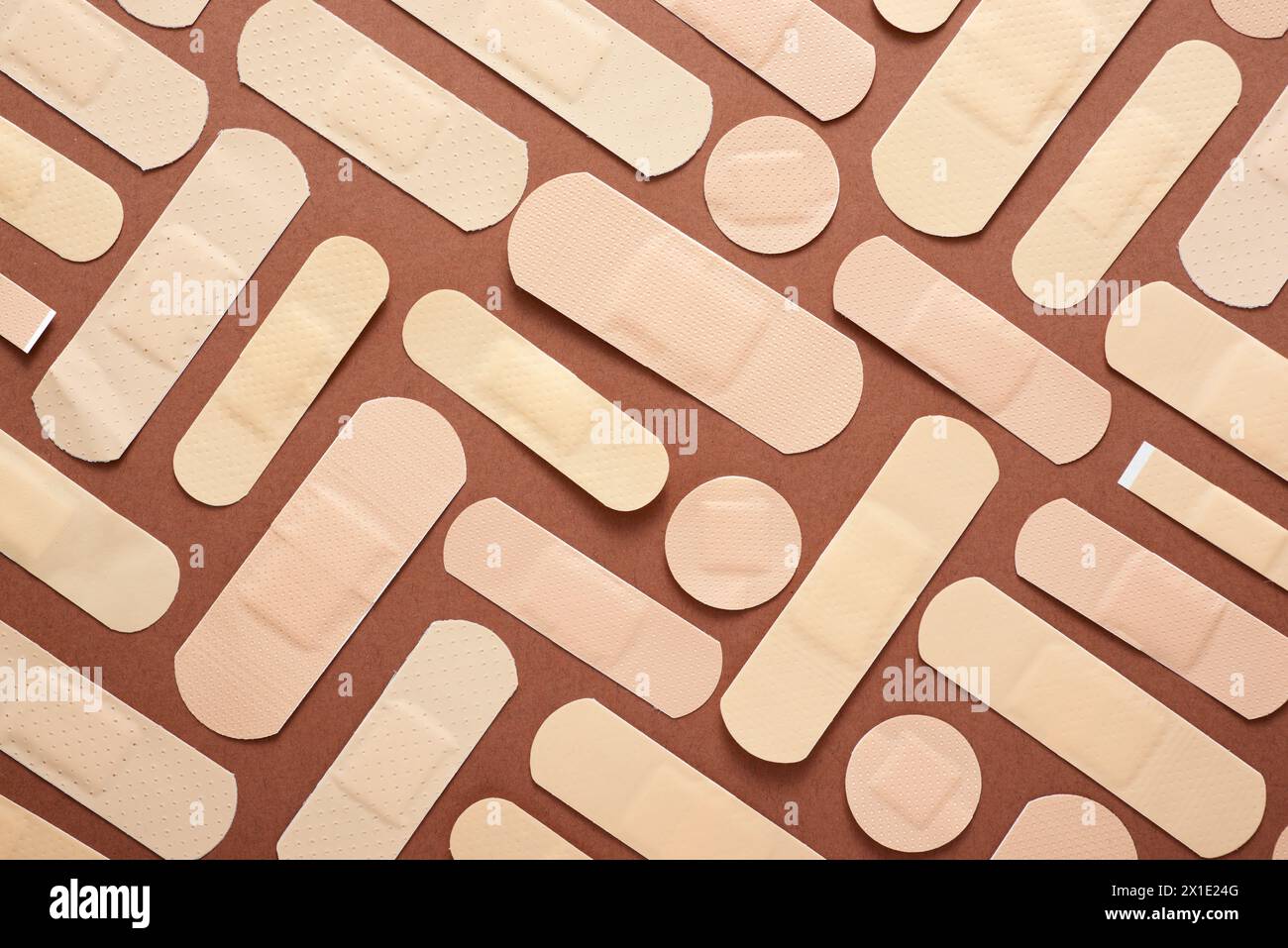 Close up of a group of first-aid plasters on a brown surface Stock ...