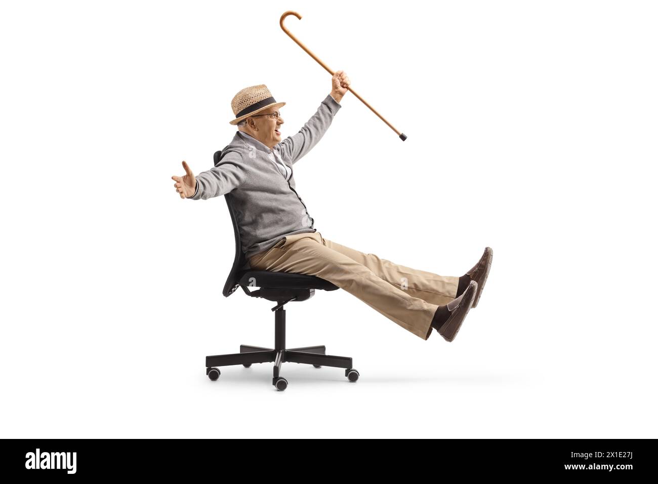 Elderly man spinning on a desk chair and holding a cane isolated on ...