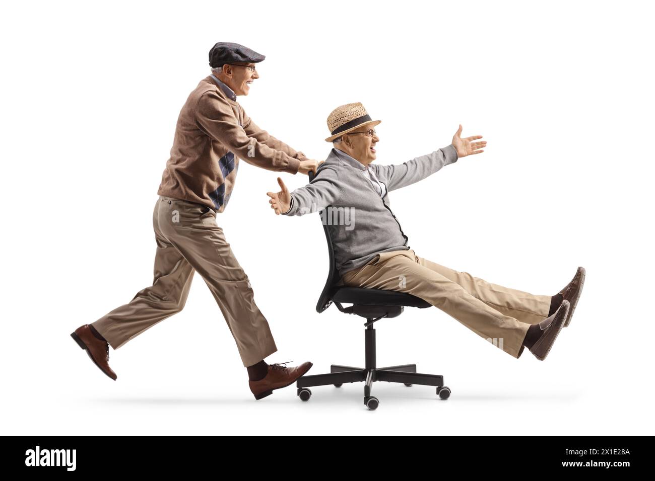 Elderly man pushing a friend on an office chair isolated on white ...