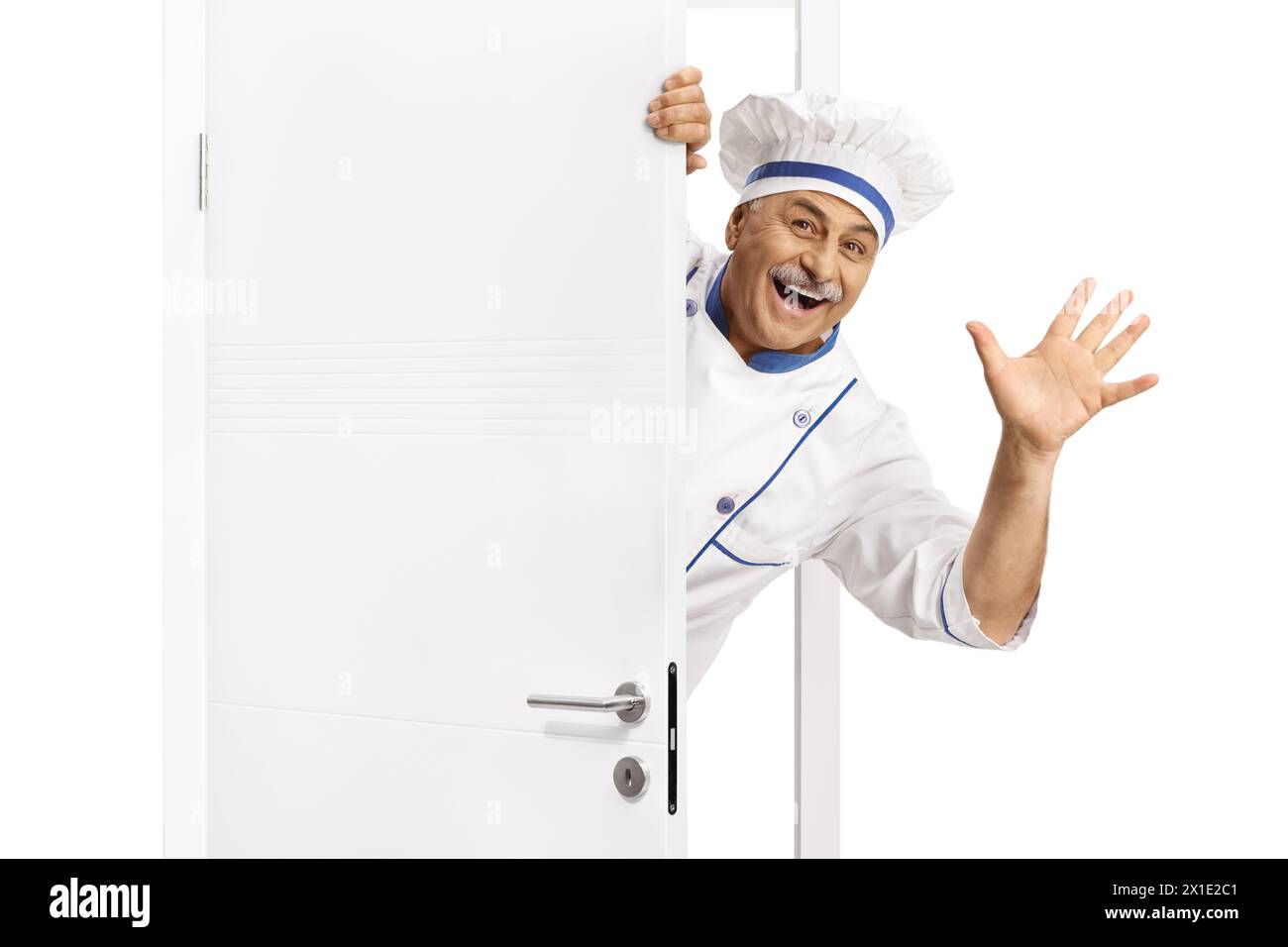 Chef waving and standing behind a door Stock Photo - Alamy
