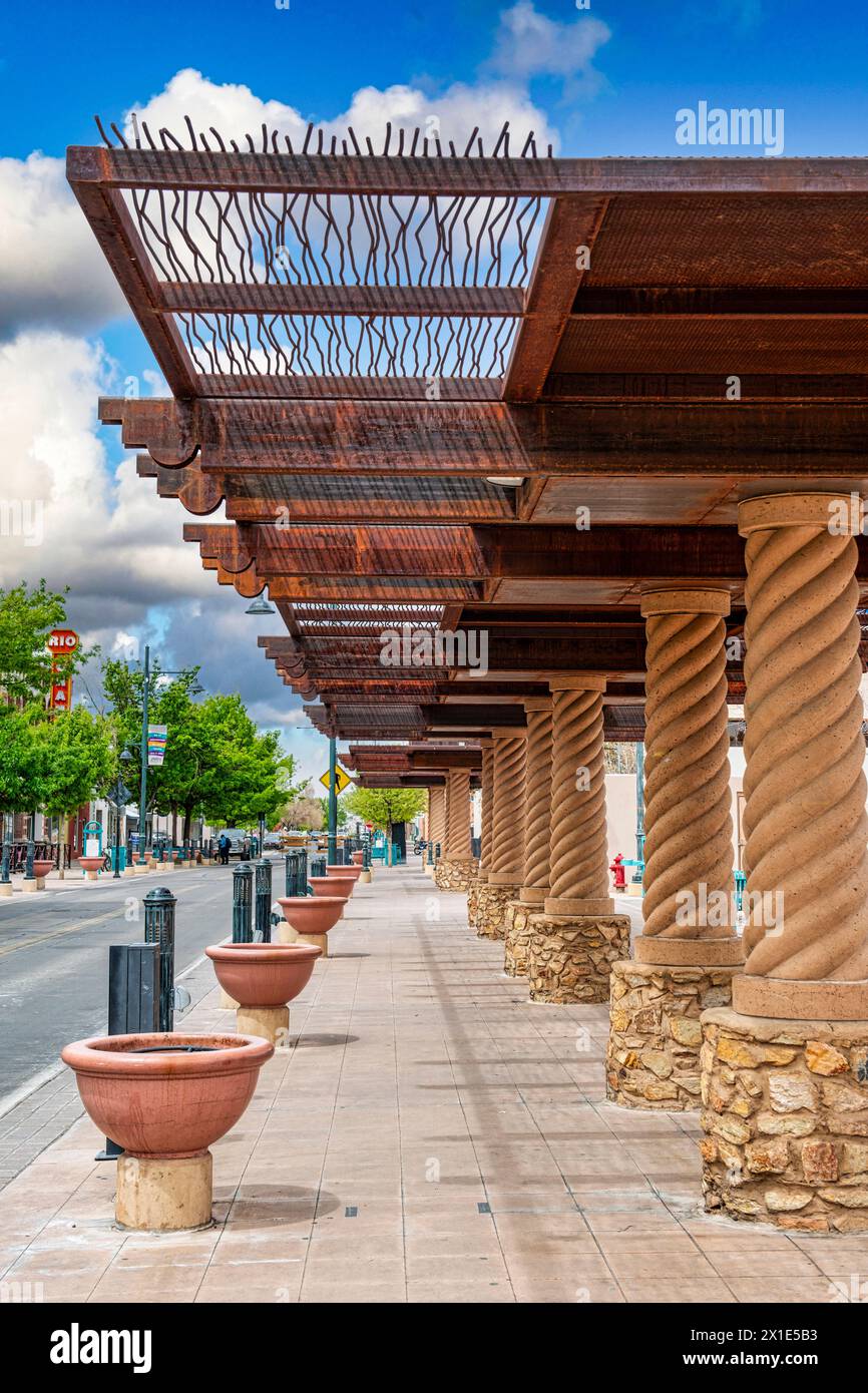 Public seating and artistic shade covering on the sidewalk along Main ...