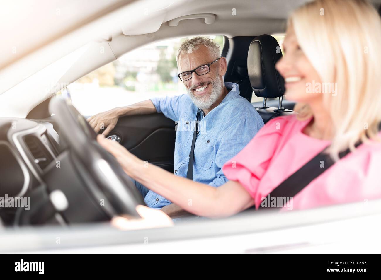 Retired wife driving with husband in passenger seat Stock Photo - Alamy