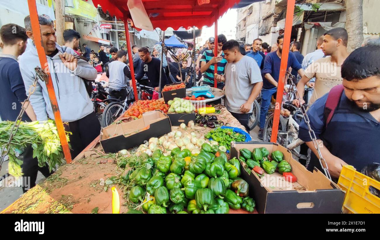 Palestinians wander in a market to buy vegetables and food in Gaza City ...