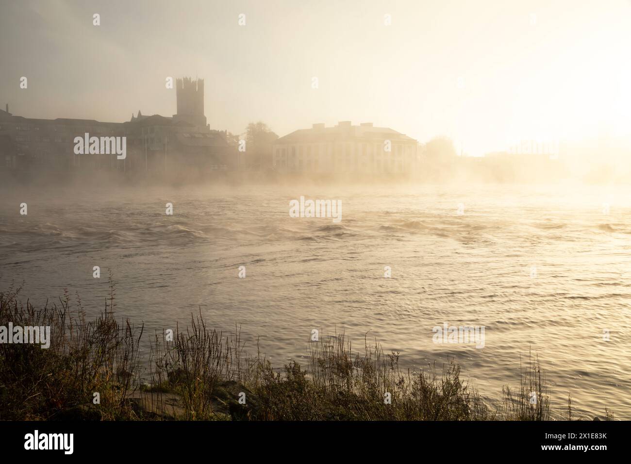 Foggy view of the medieval quarter of Limerick city from across the ...