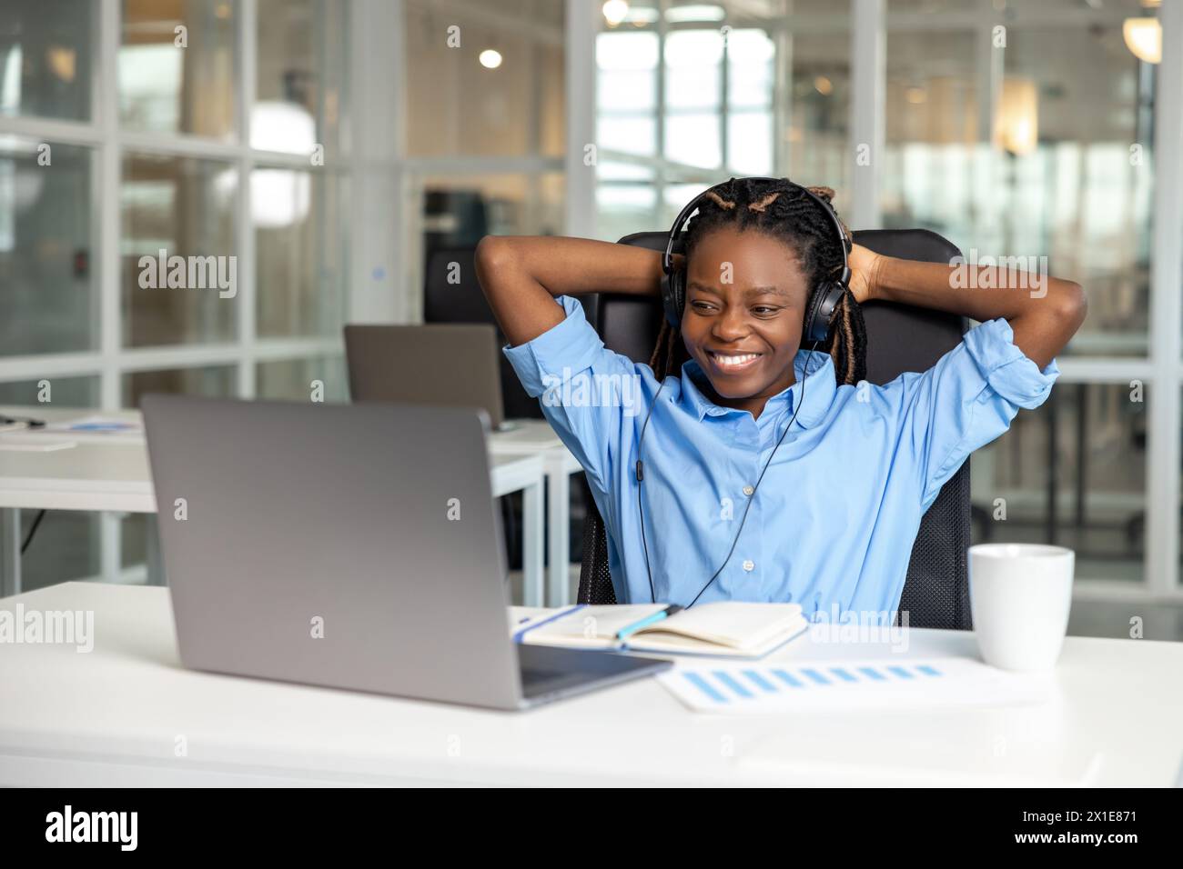 Cheerful woman call center operator having break during her work Stock ...