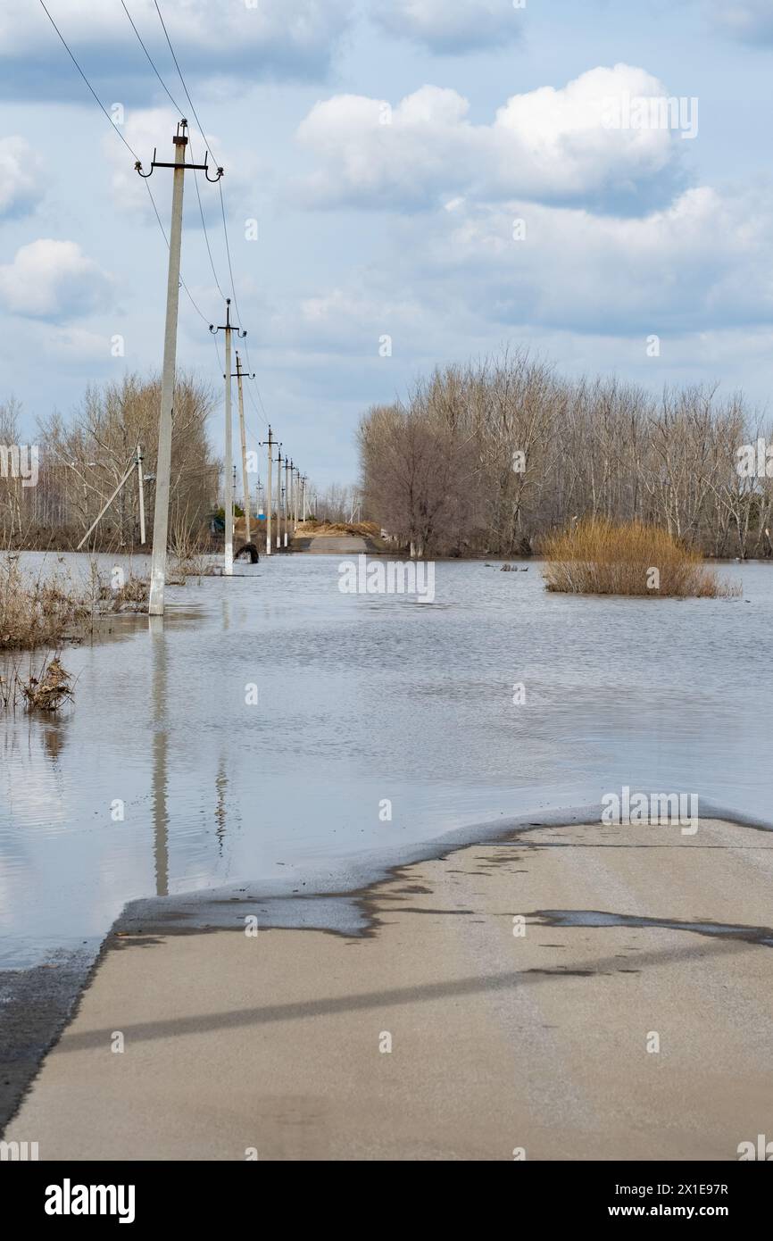 Spring flood on the river. Flood of river. Flooding of road with water ...