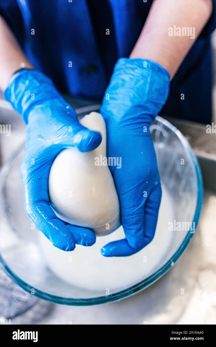 A woman working in a small family butter mill completes the final ...