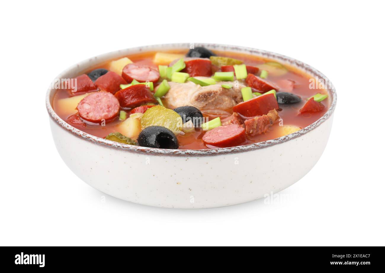 Meat solyanka soup with thin dry smoked sausages in bowl isolated on ...