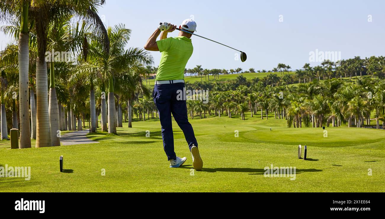 Golfer on a golf course, ready to tee off. Golfer with golf club ...